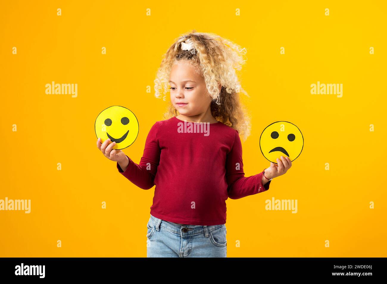 Girl Holding Sad and Happy Emoticons. Children's Emotional Balance ...