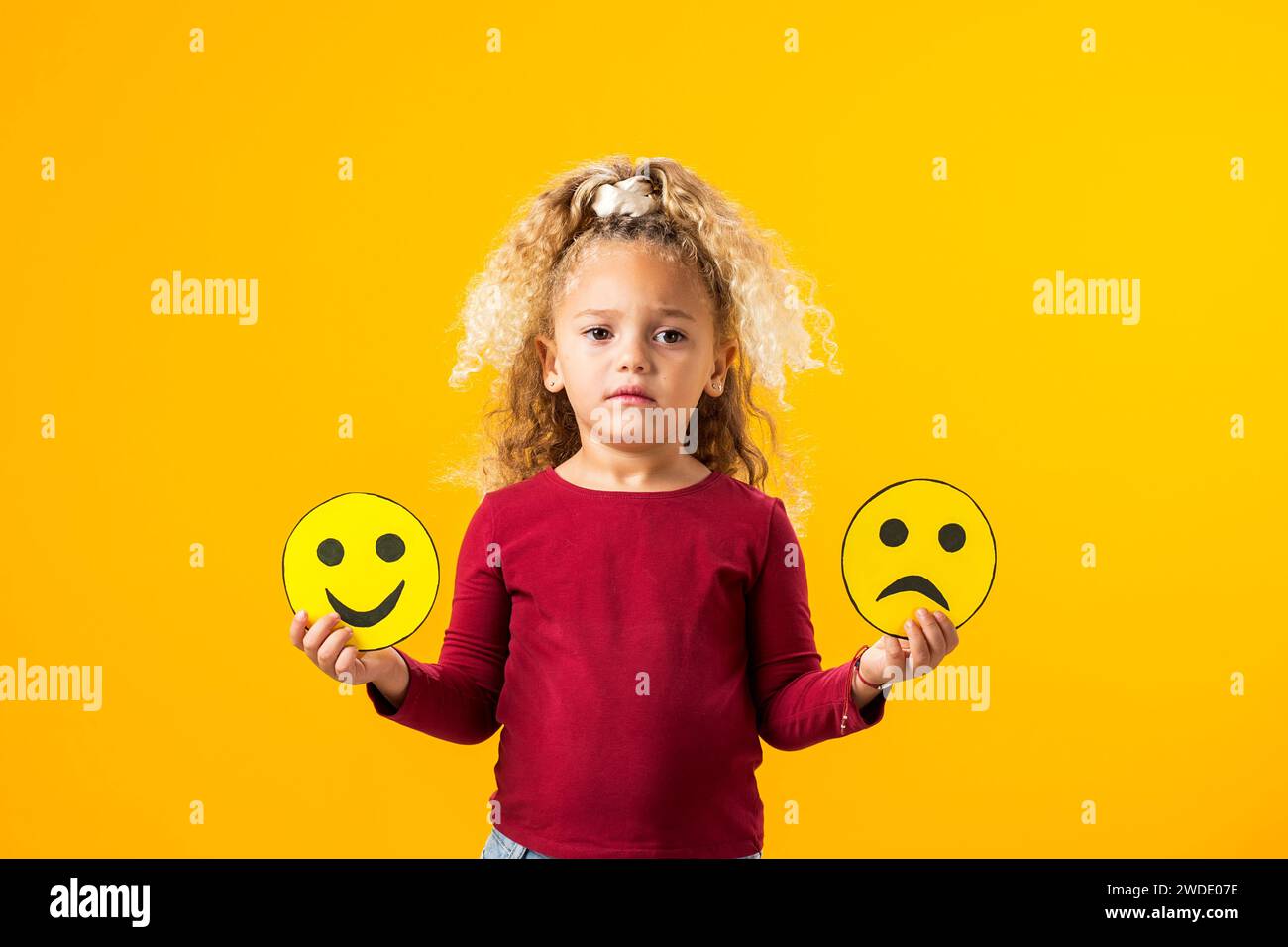 Girl Holding Sad and Happy Emoticons. Children's Emotional Balance ...