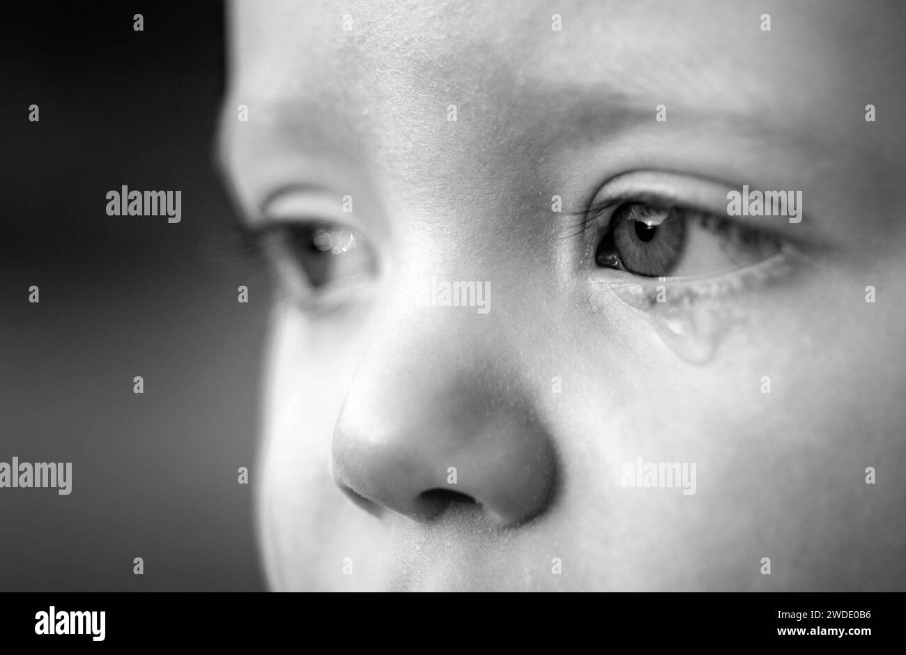 Cry baby with sky blue eyes. Little tender baby boy crying. Eye drop ...