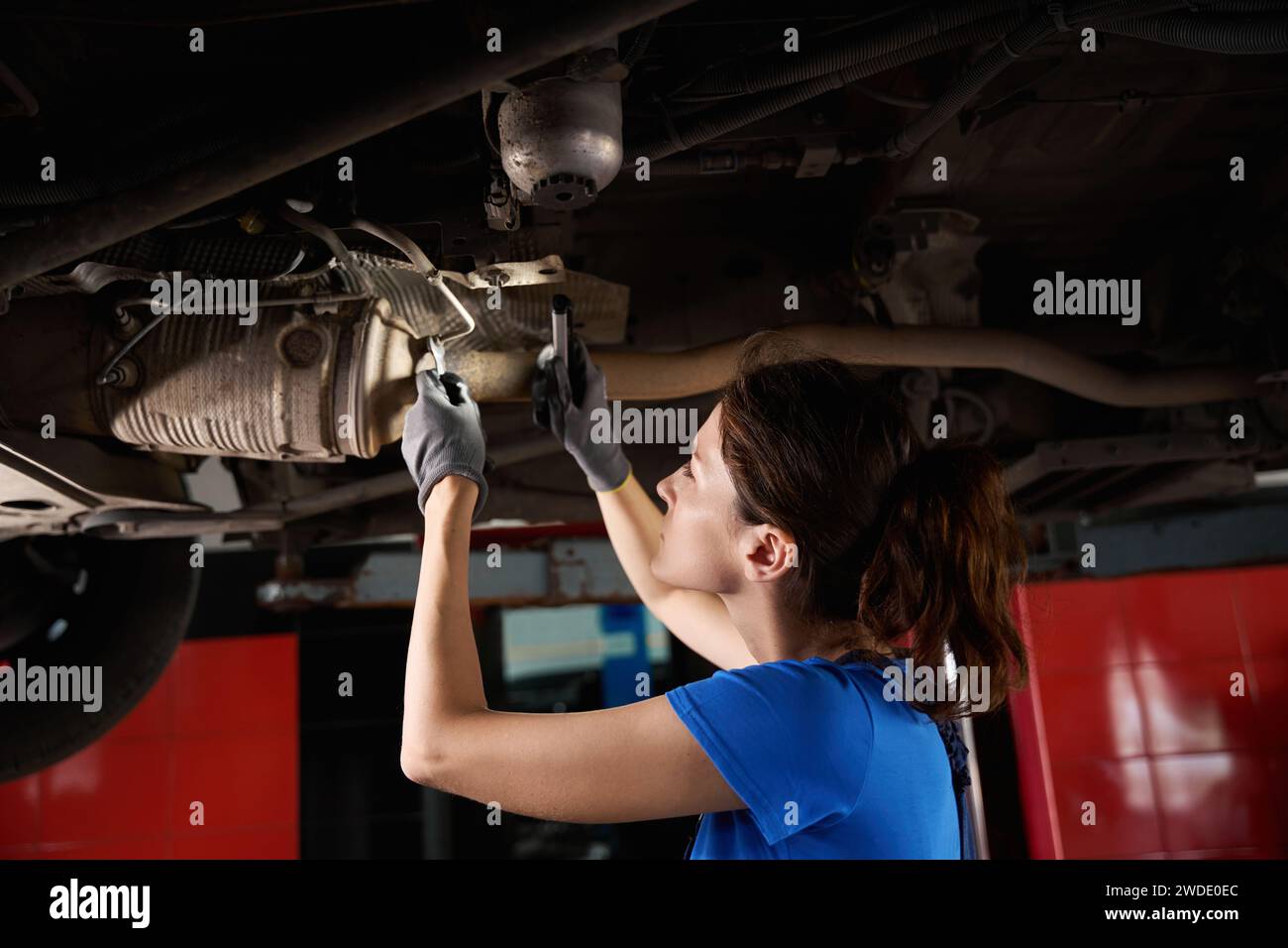 Female auto mechanic inspects the chassis of the car Stock Photo - Alamy