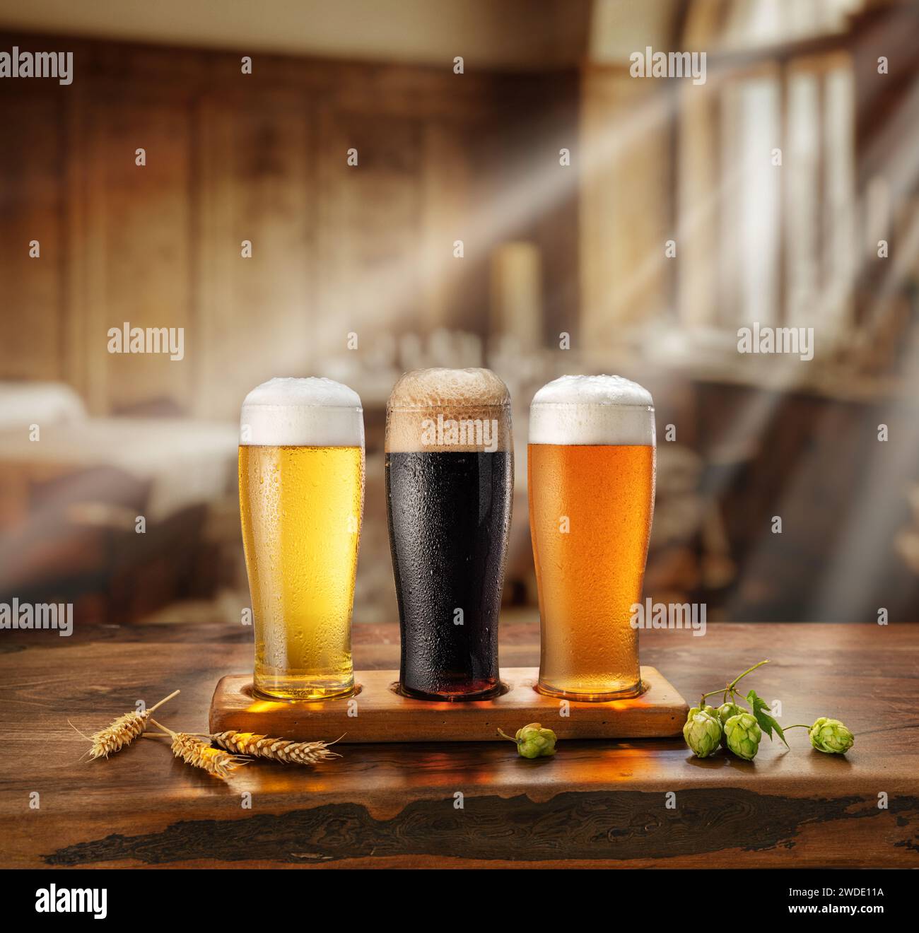 Set of different glasses of chilled beer on wooden table. Blurred old ...