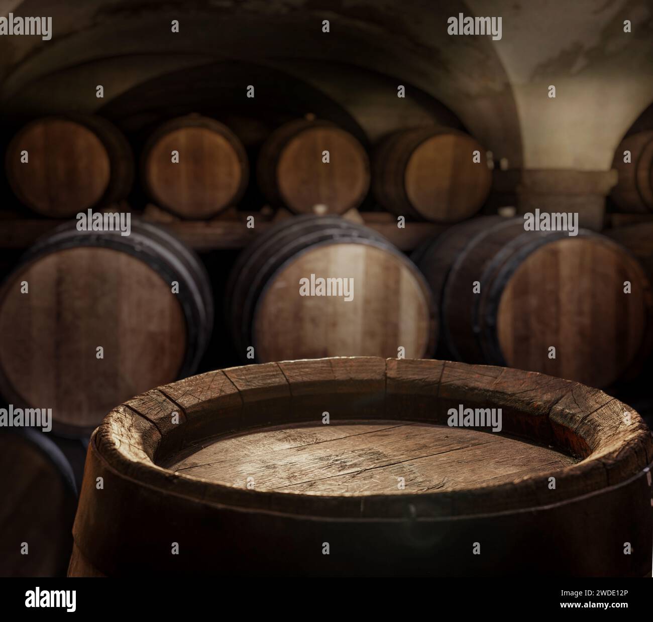 Empty top of wooden barrel and wood barrels in cellar at the background ...