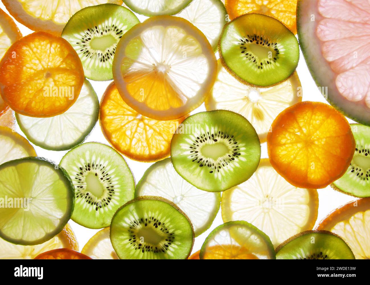 Sliced citrus fruit cross sections on white background. Food background ...