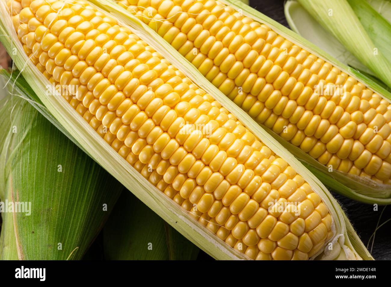 Ripe corn heads with corn whiskers and leaves. Nice vegetable cooking ...