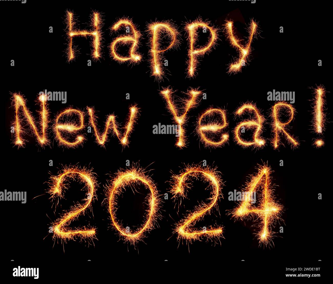 New Year greeting written with burning sparkles in the dark night Stock ...