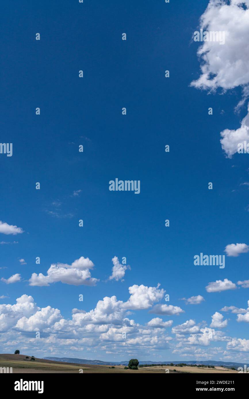 Rural landscape of fields, hills and stunning skyscape with cumulus ...