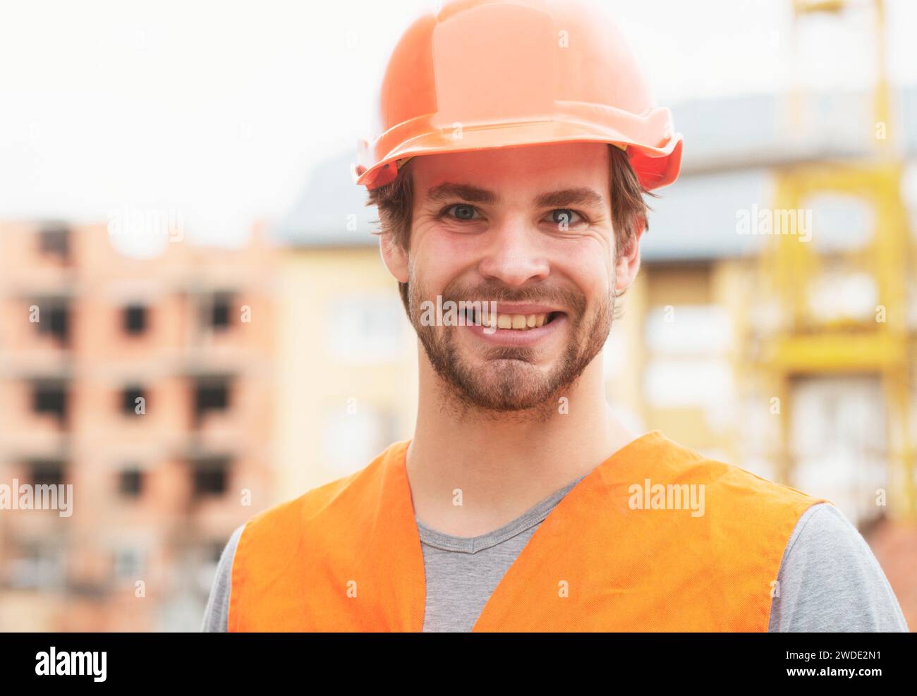 Construction worker man in work clothes and a construction helmet ...