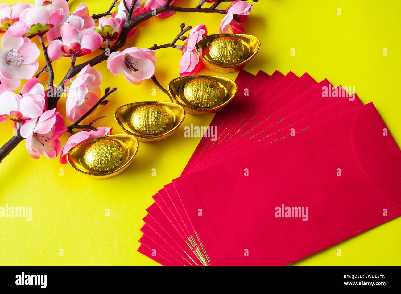 Top view of Chinese New Year red packet, cherry blossom and golden ...