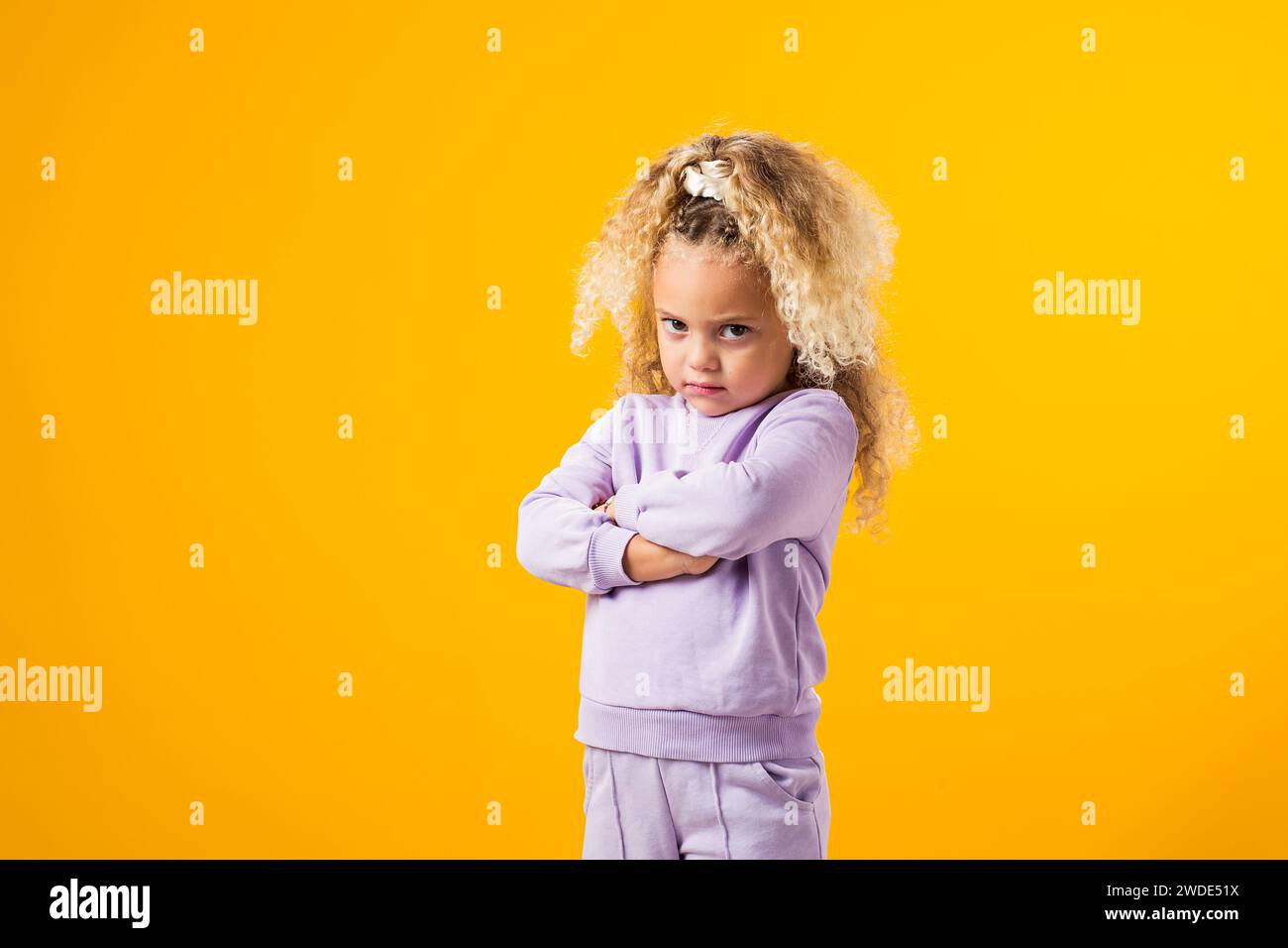 Portrait of offended child girl with crossing arms on her chest ...