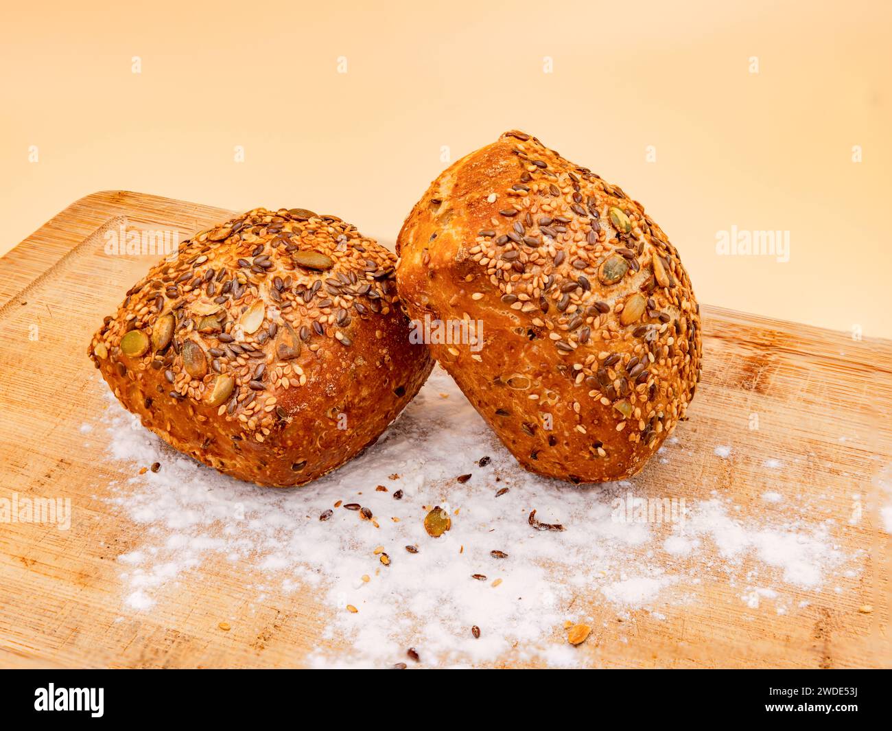 Studio shot with whole grain buns arranged on a board with flour fresh ...