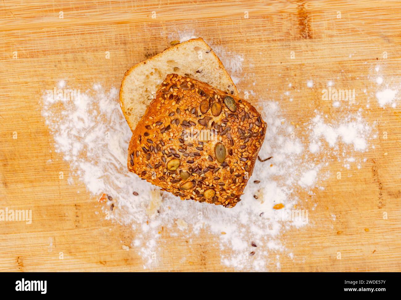 Home-baked German grain rolls fresh from the bakery arranged with flour ...