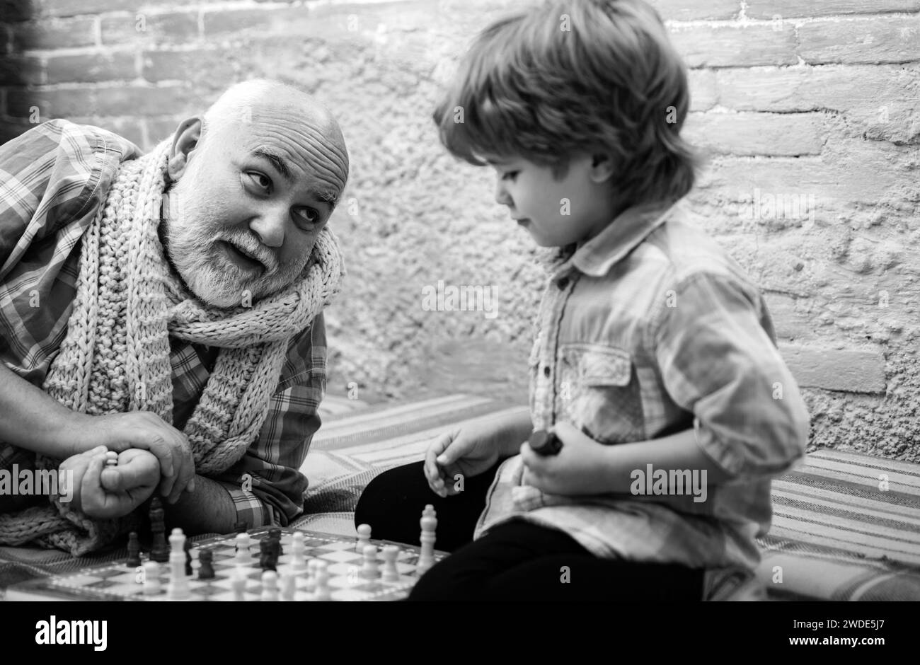 Senior man thinking about his next move in a game of chess. Grandfather ...