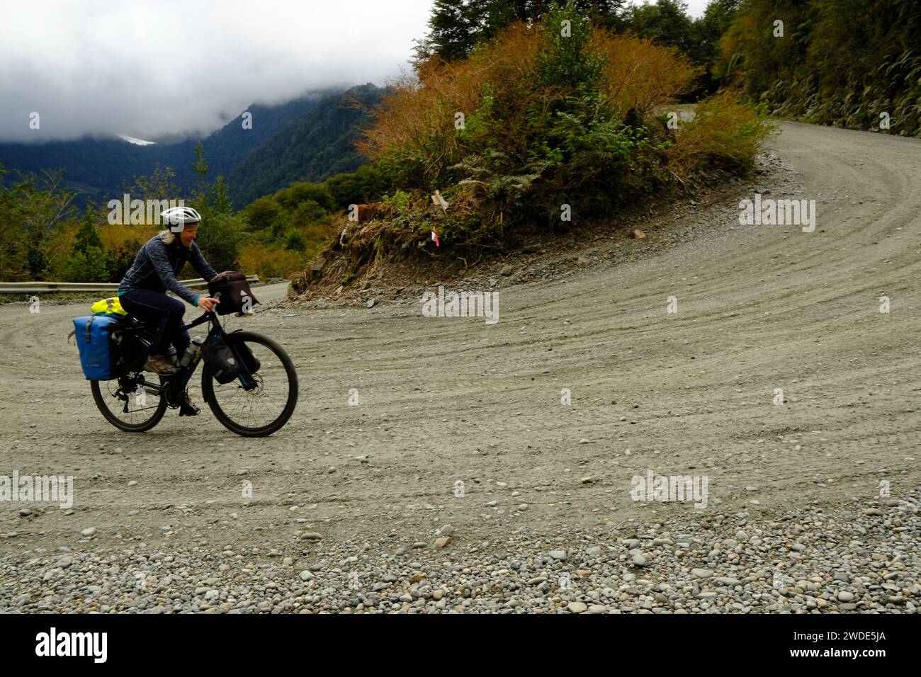Cyclist climbing the steep gravel bends up to Passo Quelat while ...