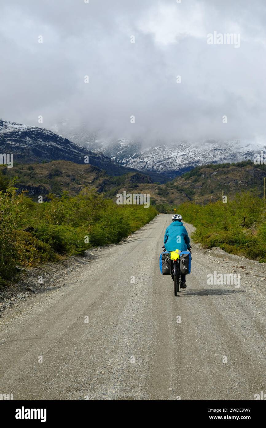 Cycling on a straight gravel road on the Carretera Austral, Chile Stock ...