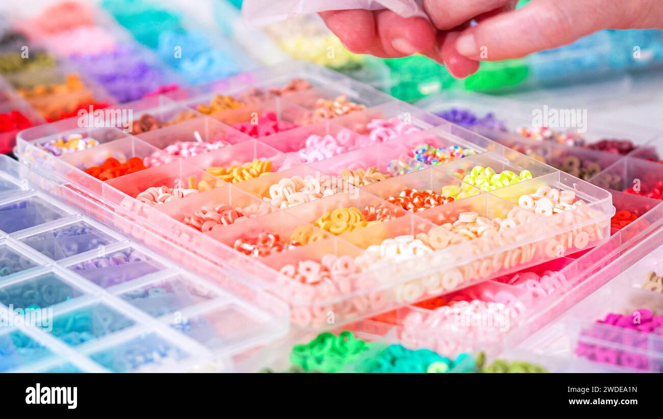 Woman's Hands Amidst a Rainbow Array of Beads for Jewelry Crafting ...