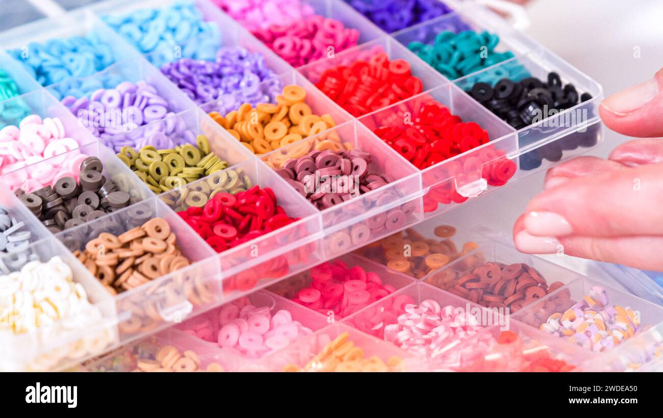 Woman's Hands Amidst a Rainbow Array of Beads for Jewelry Crafting ...