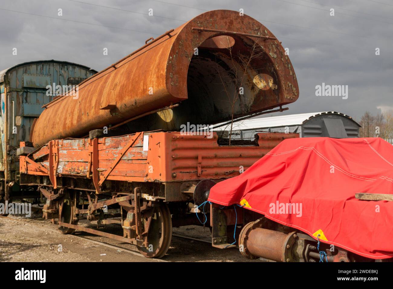 Part of a steam locomotive and goods wagons awaiting restoration at ...