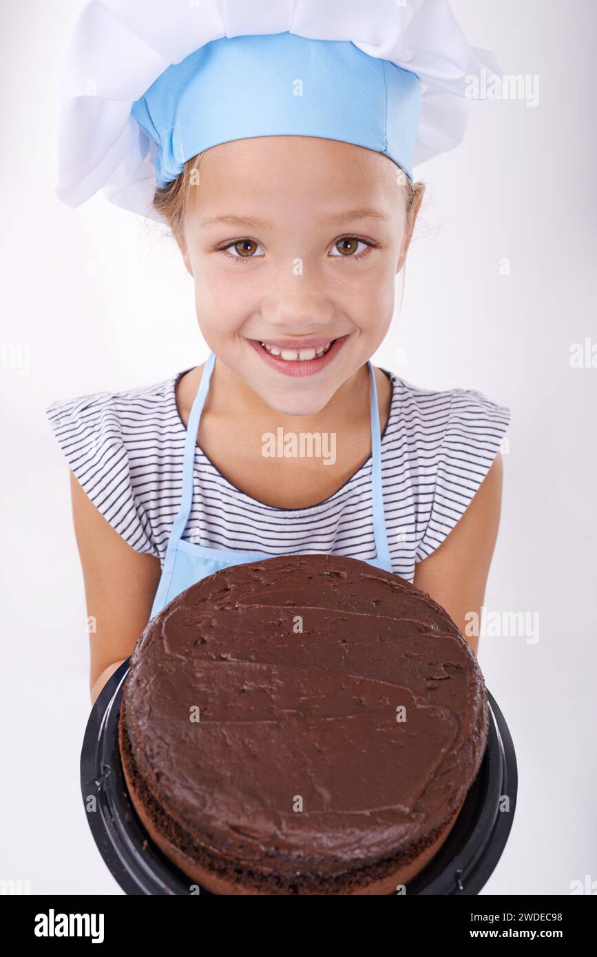 Kid, baker and portrait with cake, happy and confident with child ...