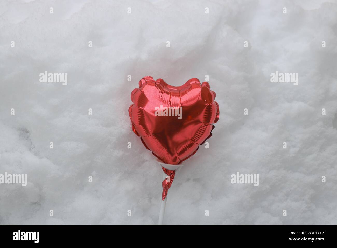 Red balloon in the snow Stock Photo - Alamy