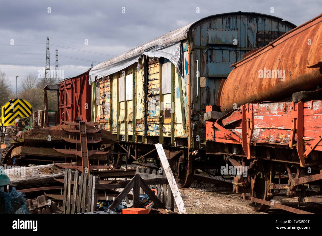 Part of a steam locomotive and goods wagons awaiting restoration at ...