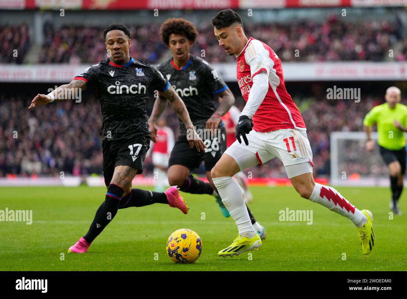 Arsenal's Gabriel Martinelli, right, challenges for the ball with ...
