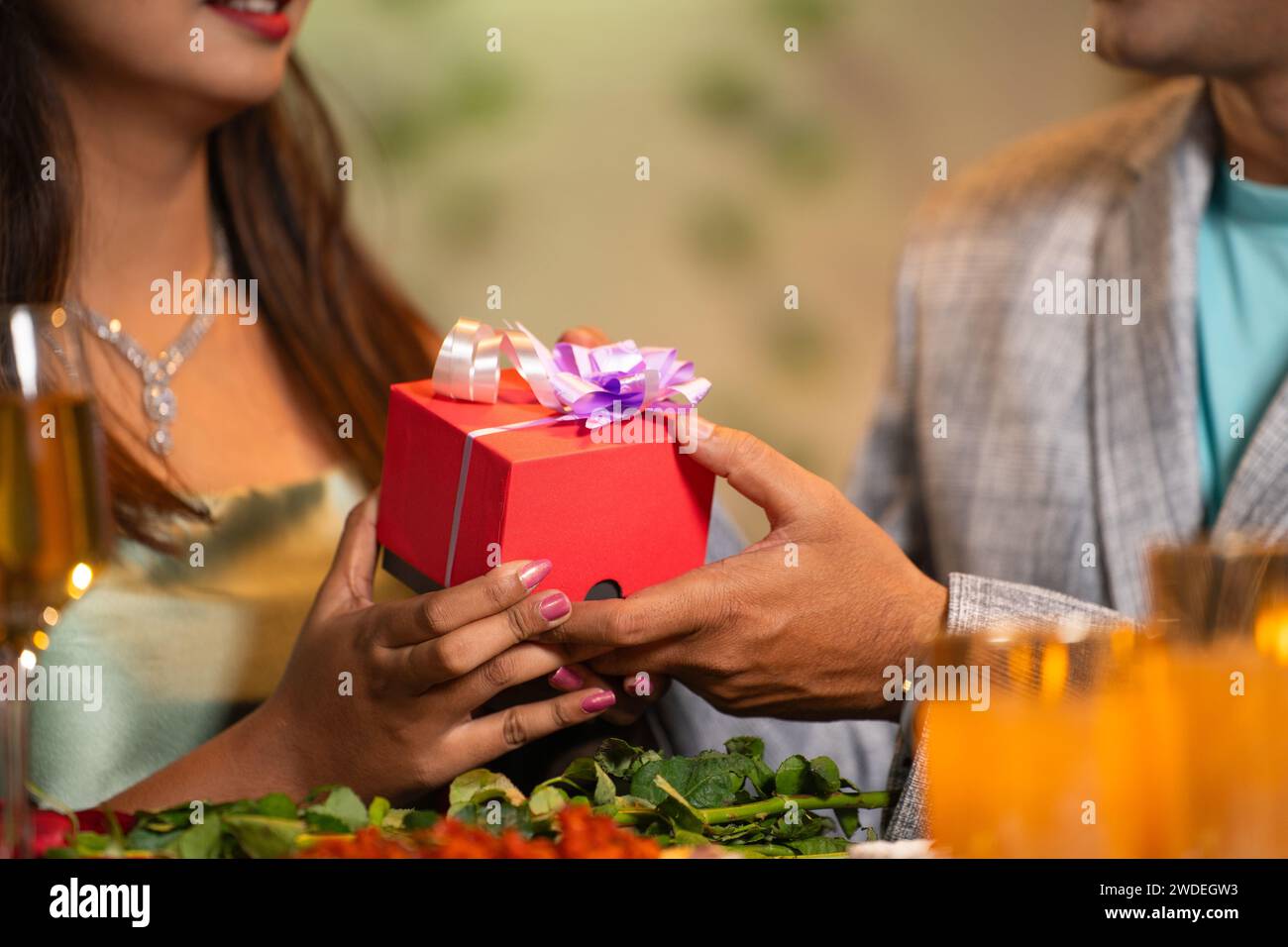 Close up shot, Boyfriend giving surprise gift to girlfriend during ...