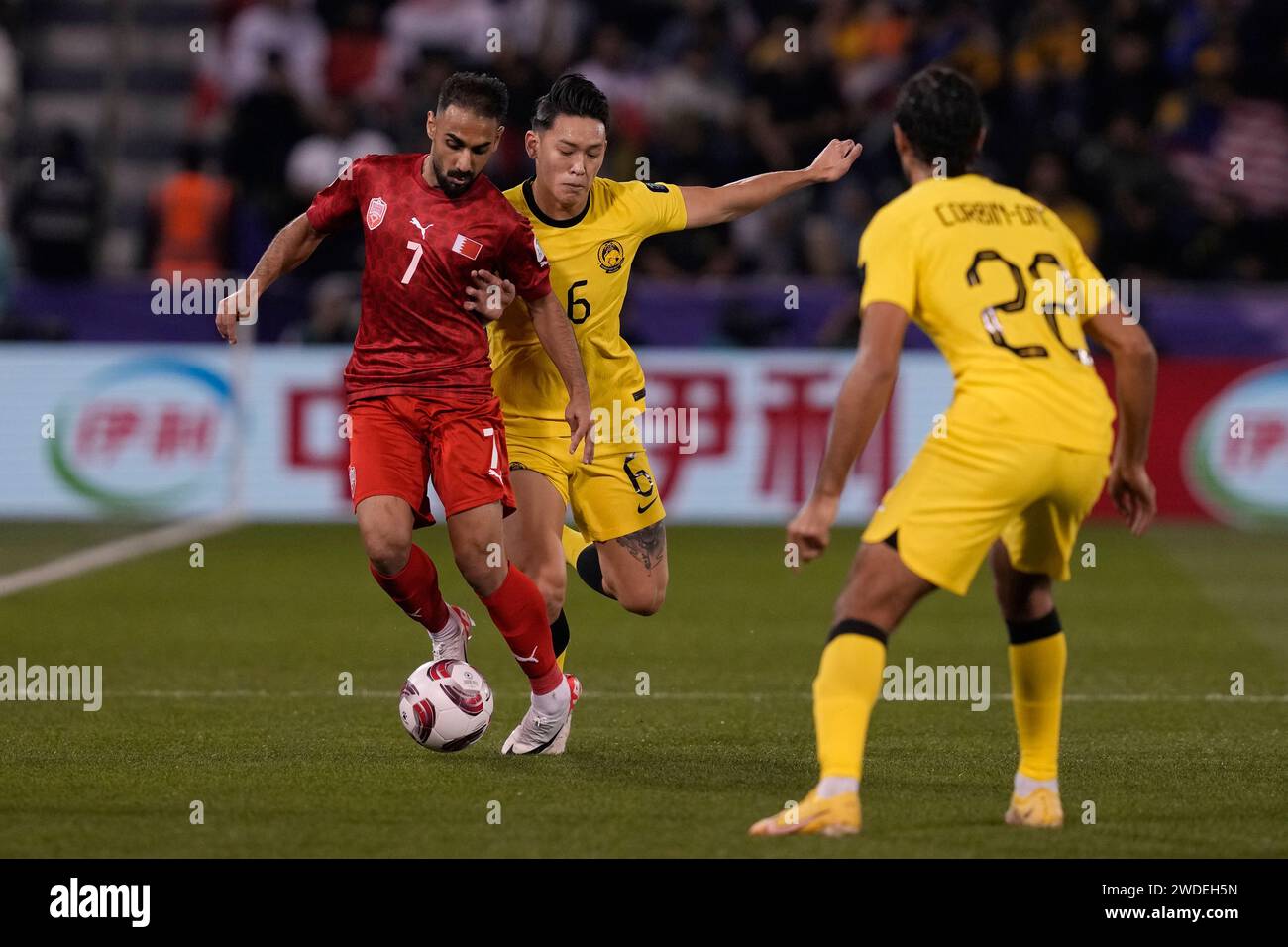 Bahrain's Ali Madan, left, and Malaysia's Dominic Tan vie for the ball ...