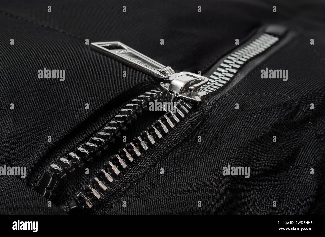 Metal zipper on a black background, close-up Stock Photo - Alamy