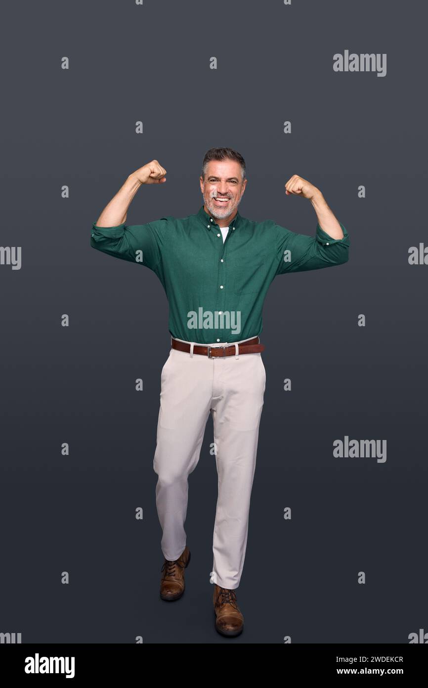 Happy middle aged business man winner raising arms celebrating success ...