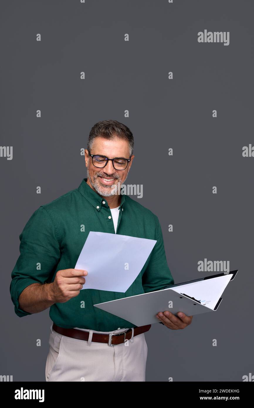 Smiling middle aged business man lawyer holding documents isolated on ...