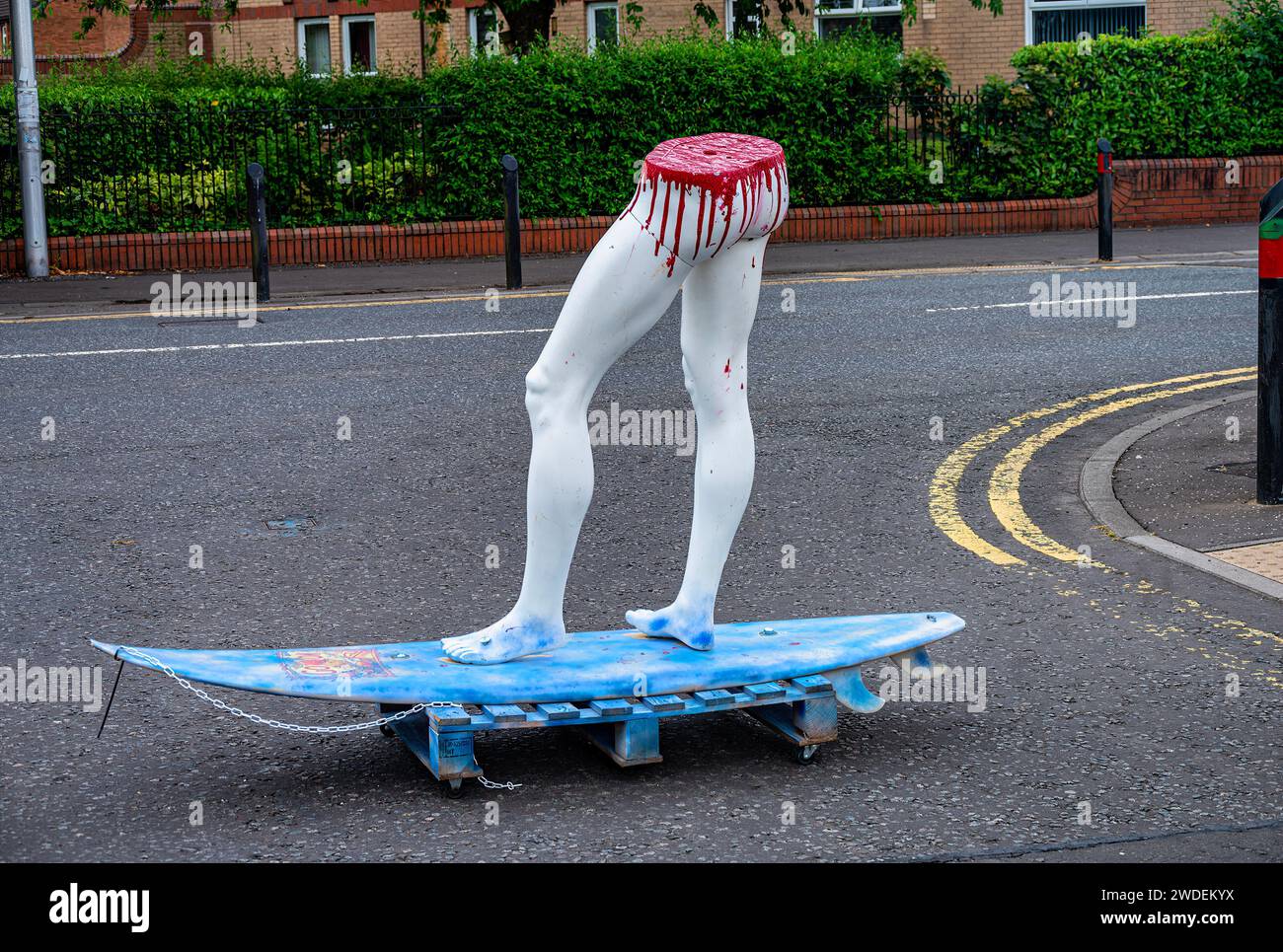 Quirky victim of shark attack on surf board at outdoor market Stock ...