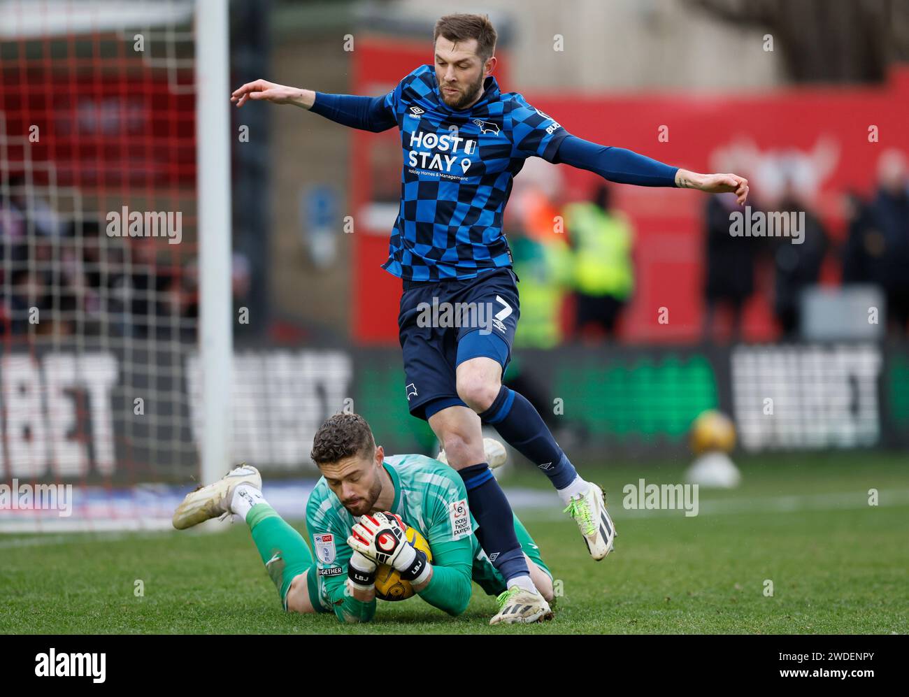 Lincoln City goalkeper Lukas Jensen keeps the ball from Derby County's ...