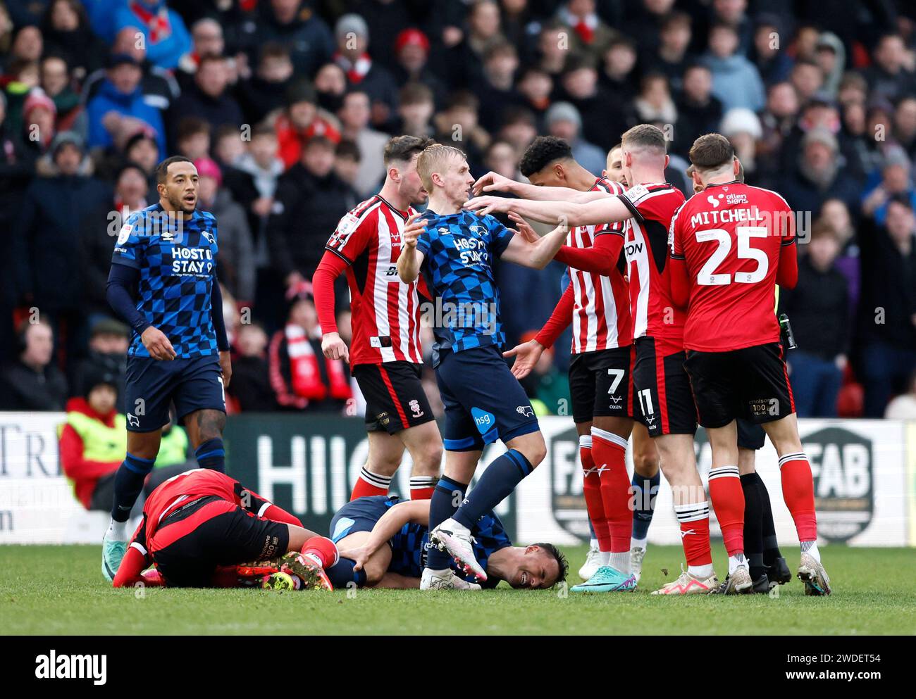 Tempers fray after Derby County's Kane Wilson is booked for a foul on ...