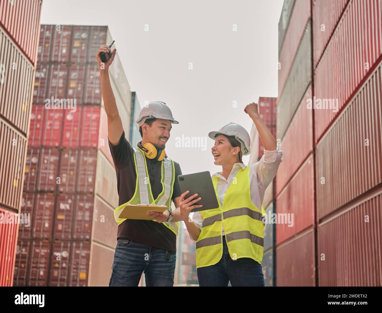 Asian happy worker and engineer co-working with laptop are satisfied with result of their work ...