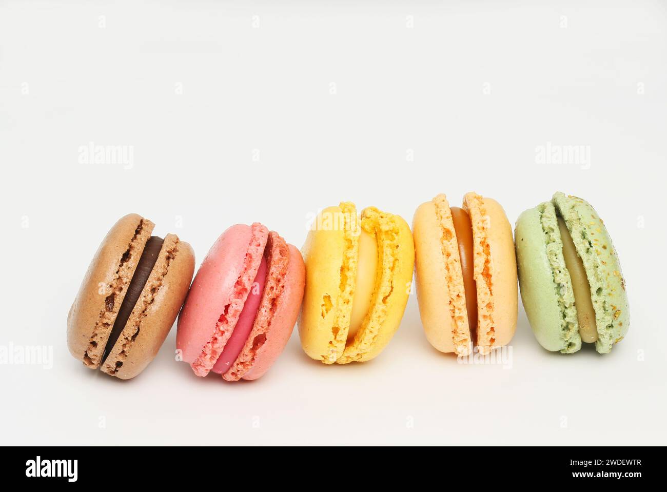 Selection of macarons in a line on a white background Stock Photo - Alamy