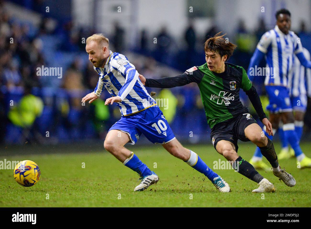 Tatsuhiro Sakamoto of Coventry City looks to tackle Barry Bannan of ...