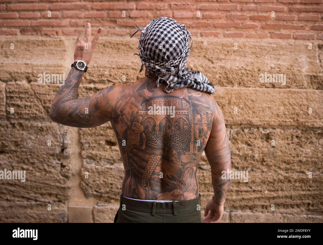 Malaga, Spain. 20th Jan, 2024. A man poses for a photo showing a tattoo ...
