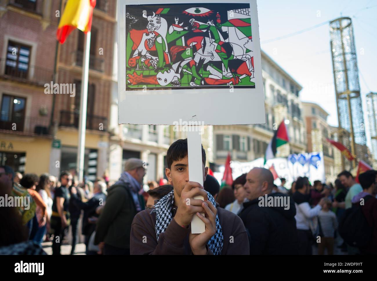 Malaga, Spain. 20th Jan, 2024. A protester holds a placard depicting ...
