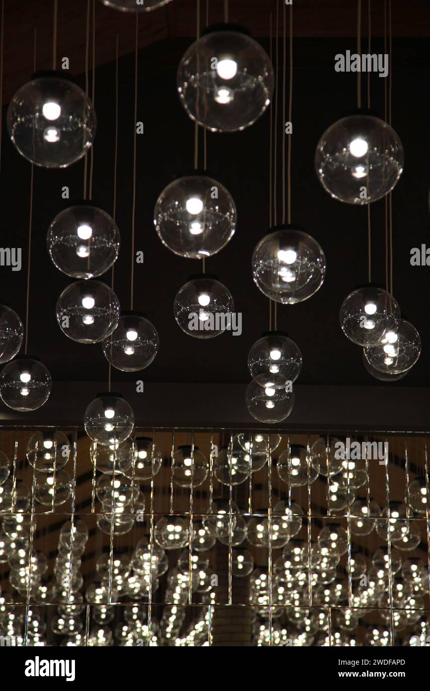 Round lamps hanging from ceiling in restaurant. Lamps decorated on the ...