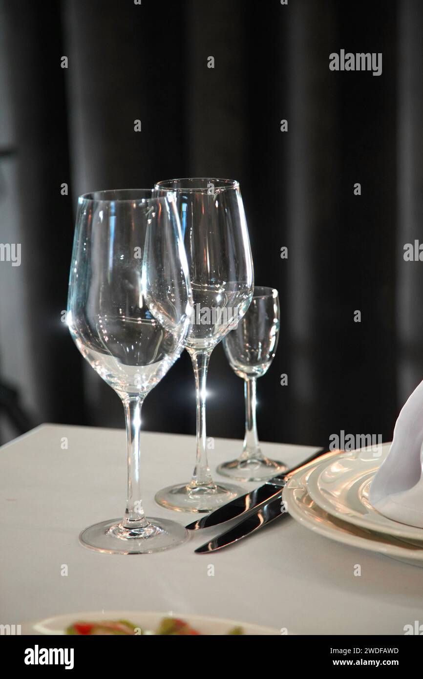 Table setting in a restaurant. Table setting with glasses, cutlery and ...