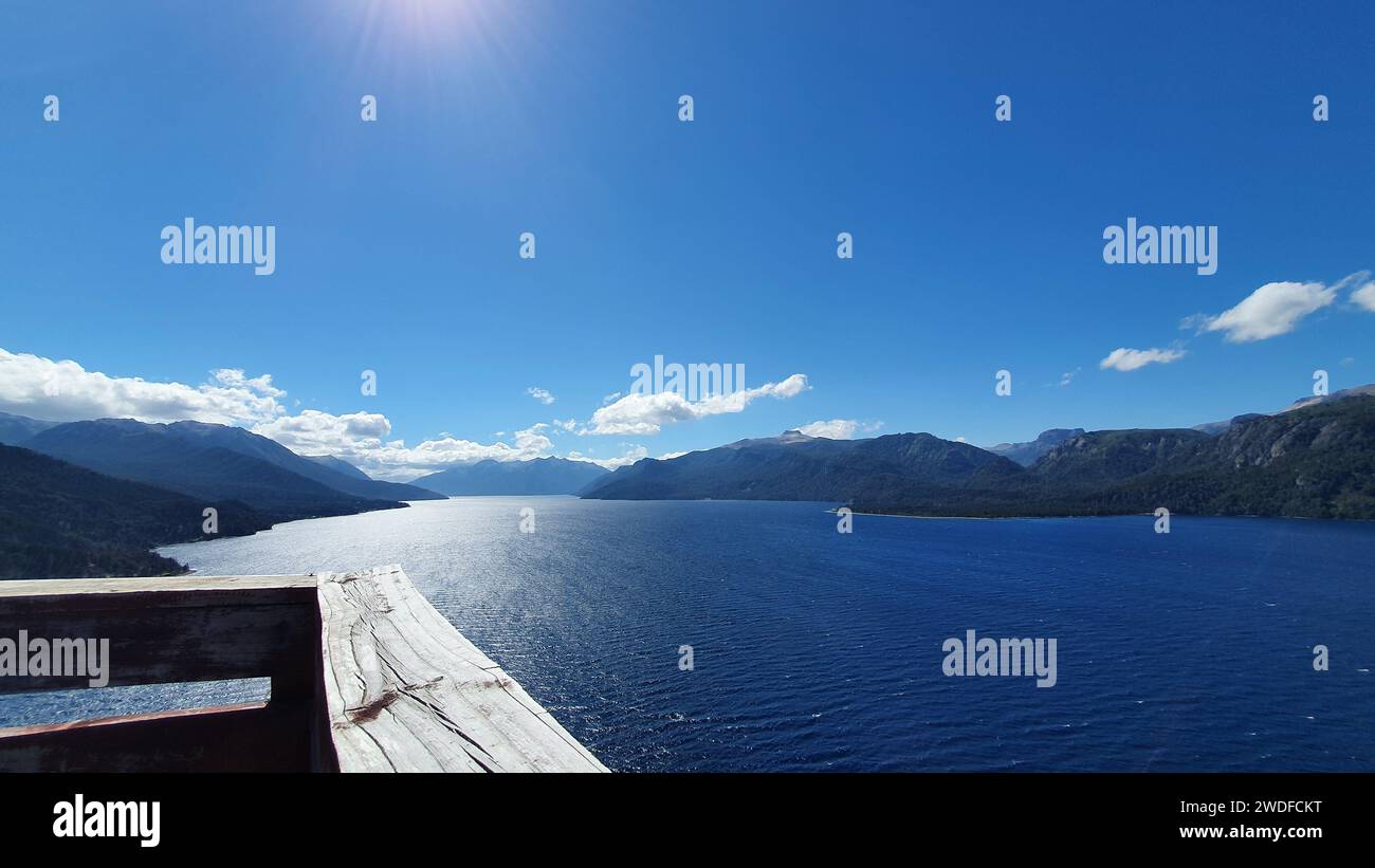 A scenic bench with a breathtaking view of water, mountains, and a ...