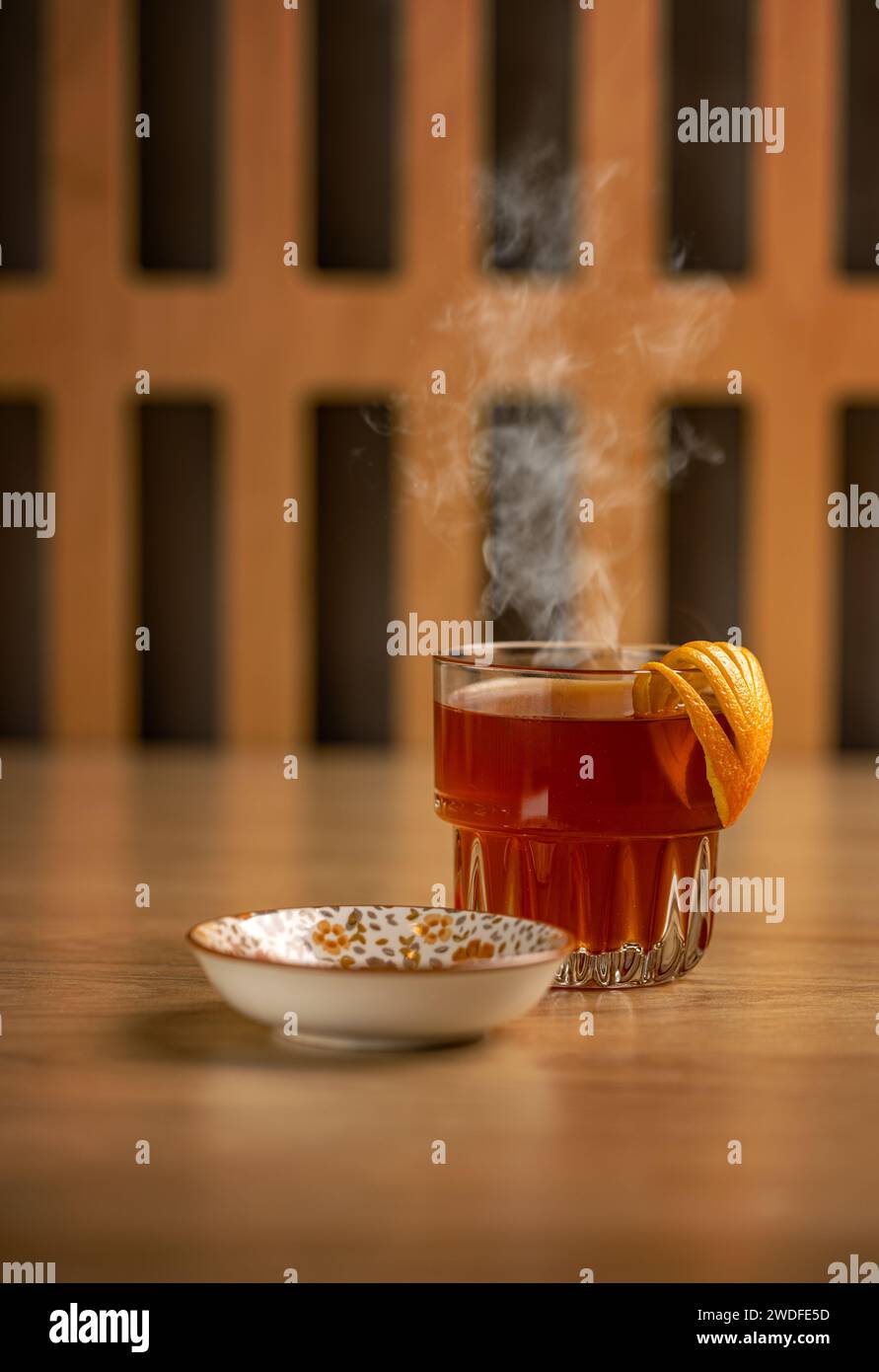 Glass cup of hot tea decorated with orange peel Stock Photo - Alamy