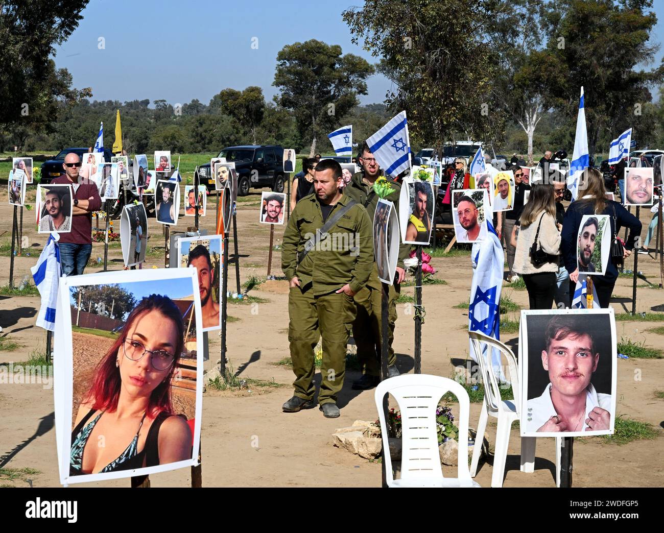 Reim, Israel. 20th Jan, 2024. Israeli soldiers walk by national flags ...