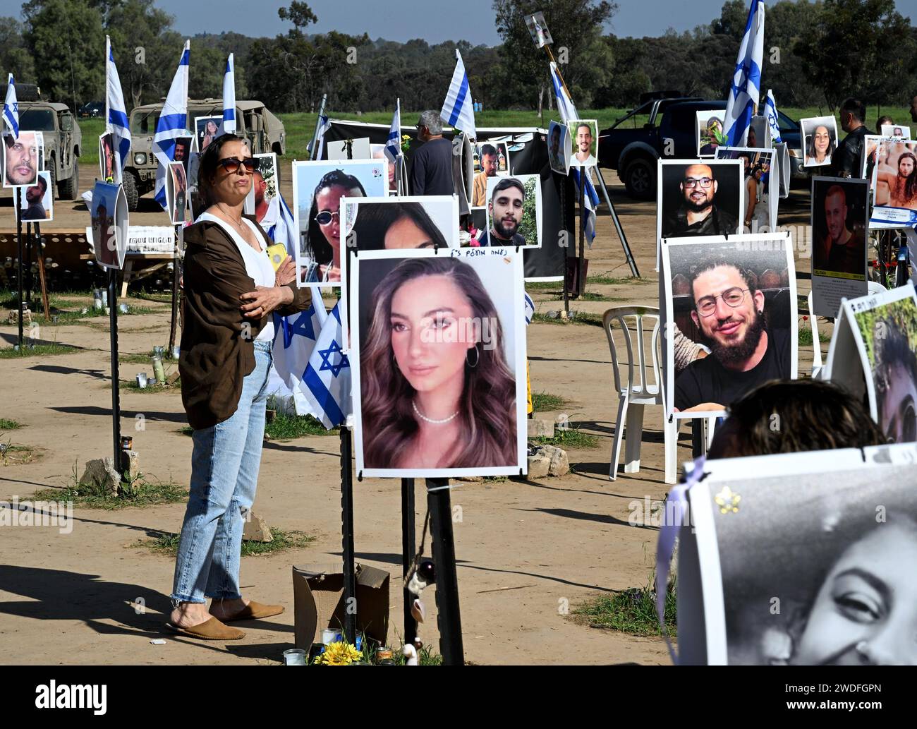 Reim, Israel. 20th Jan, 2024. A woman looks at portraits of Israelis ...