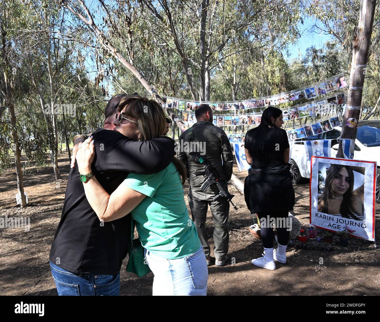Reim, Israel. 20th Jan, 2024. People hug near a makeshift memorial with ...