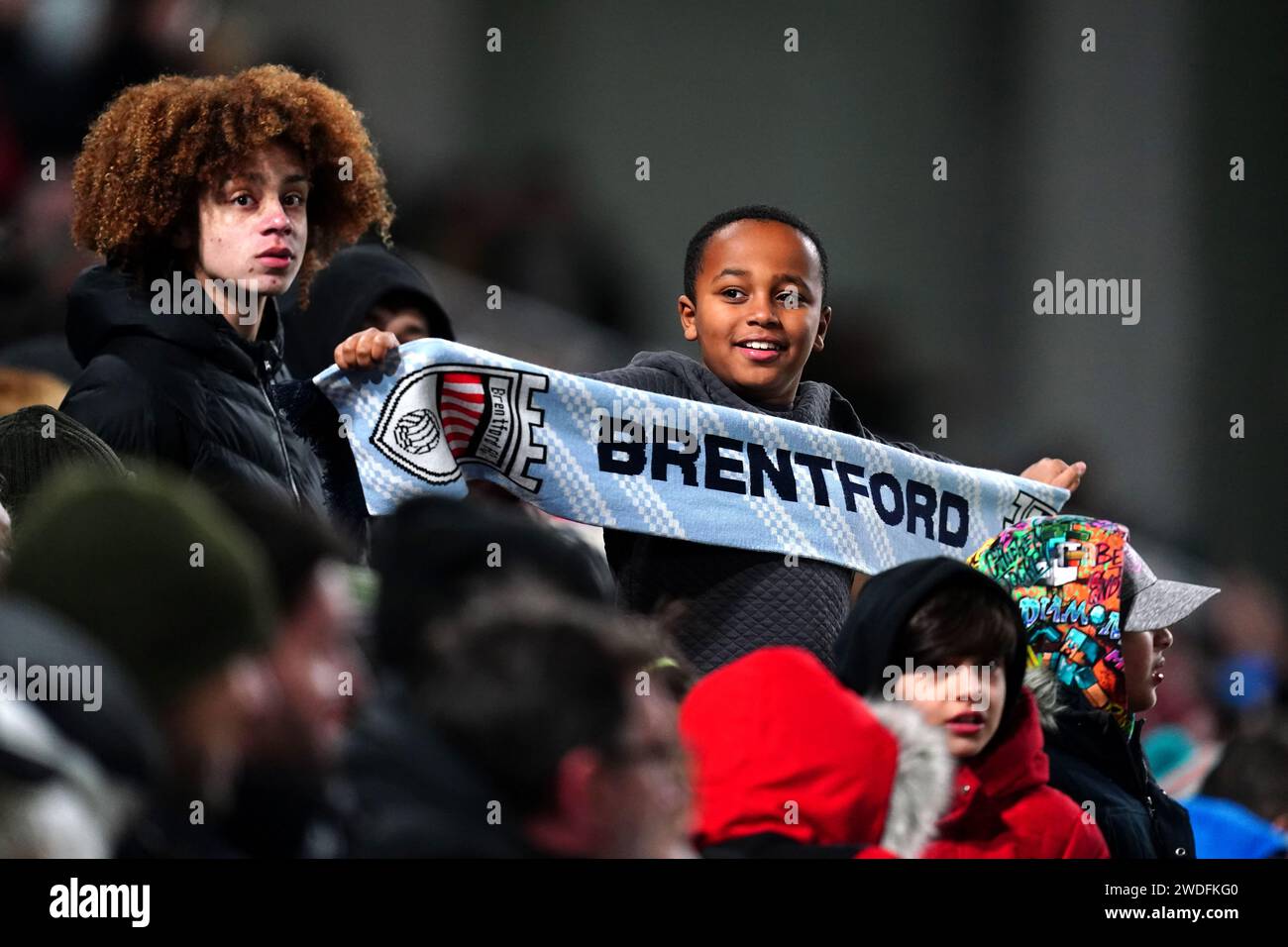A young Brentford fan holds up a scarf during the Premier League match ...