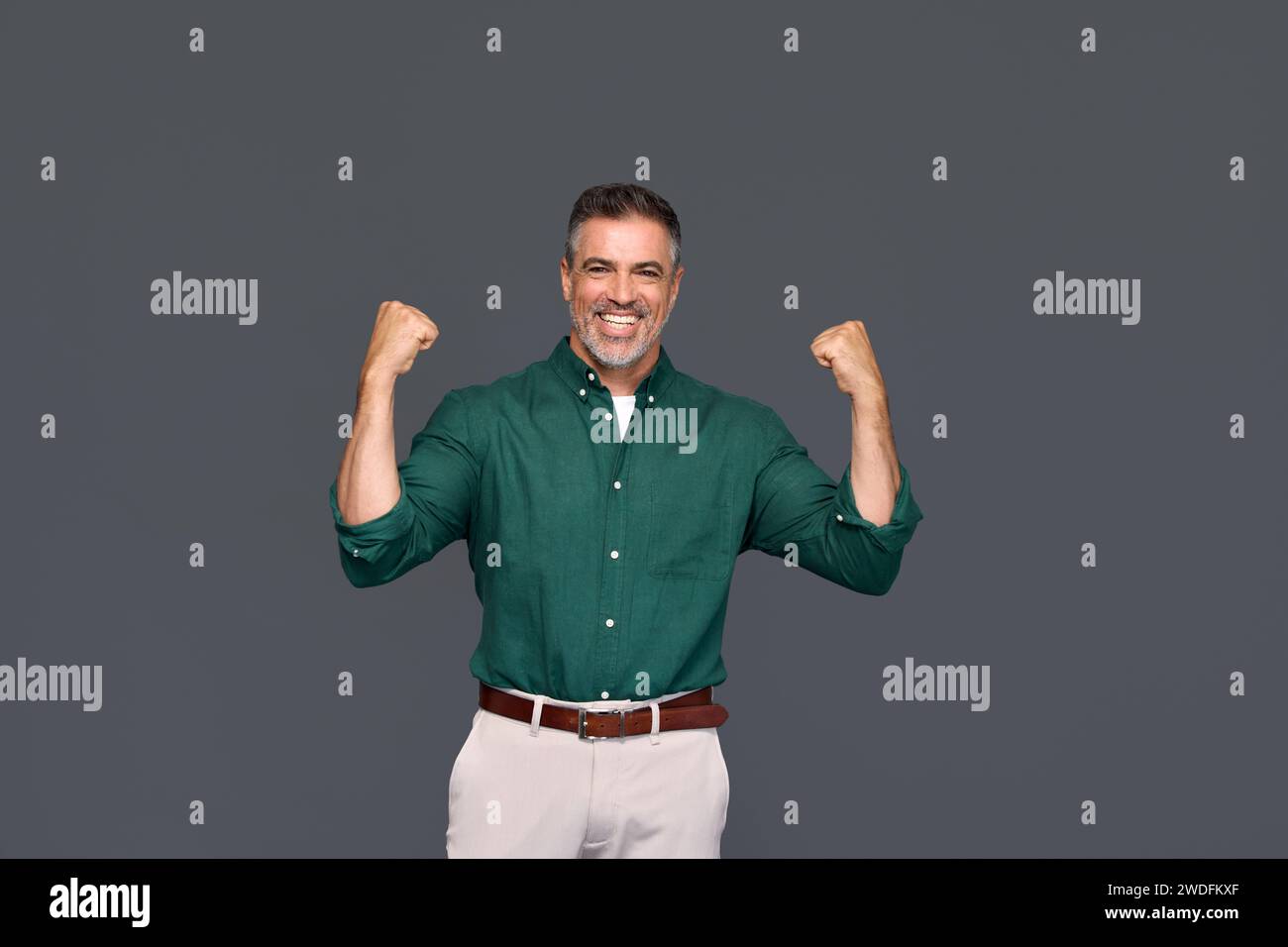 Happy middle aged business man winner raising arms celebrating success ...