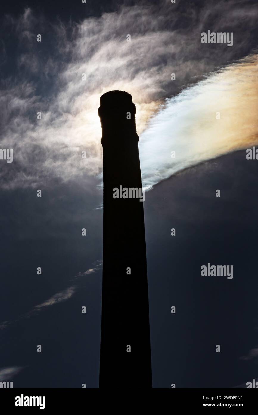 Brick factory chimney with iridescent clouds Stock Photo - Alamy