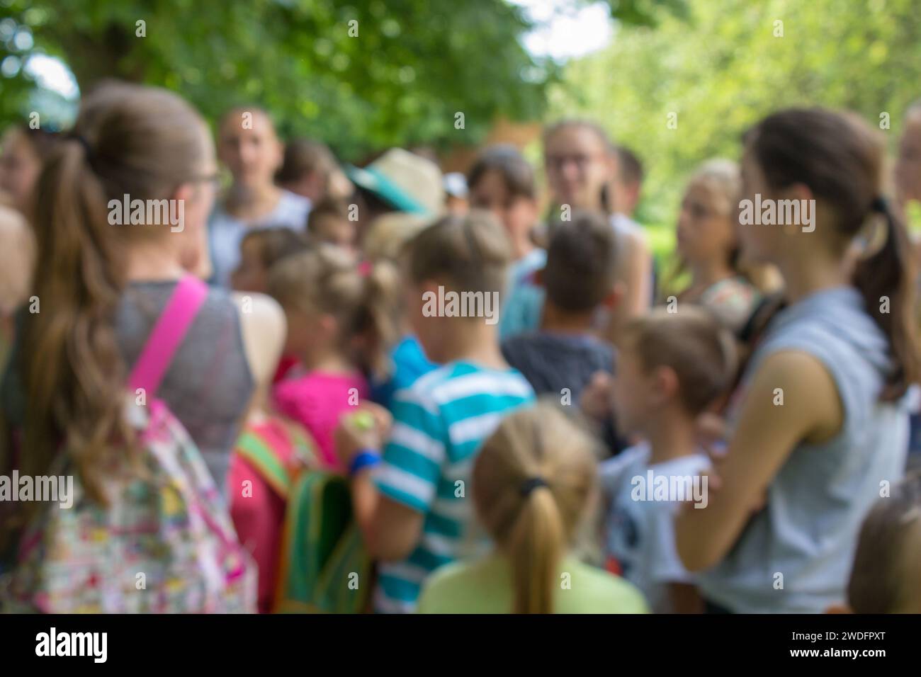 group of schoolchildren children on a tour of the nature of a blurred ...