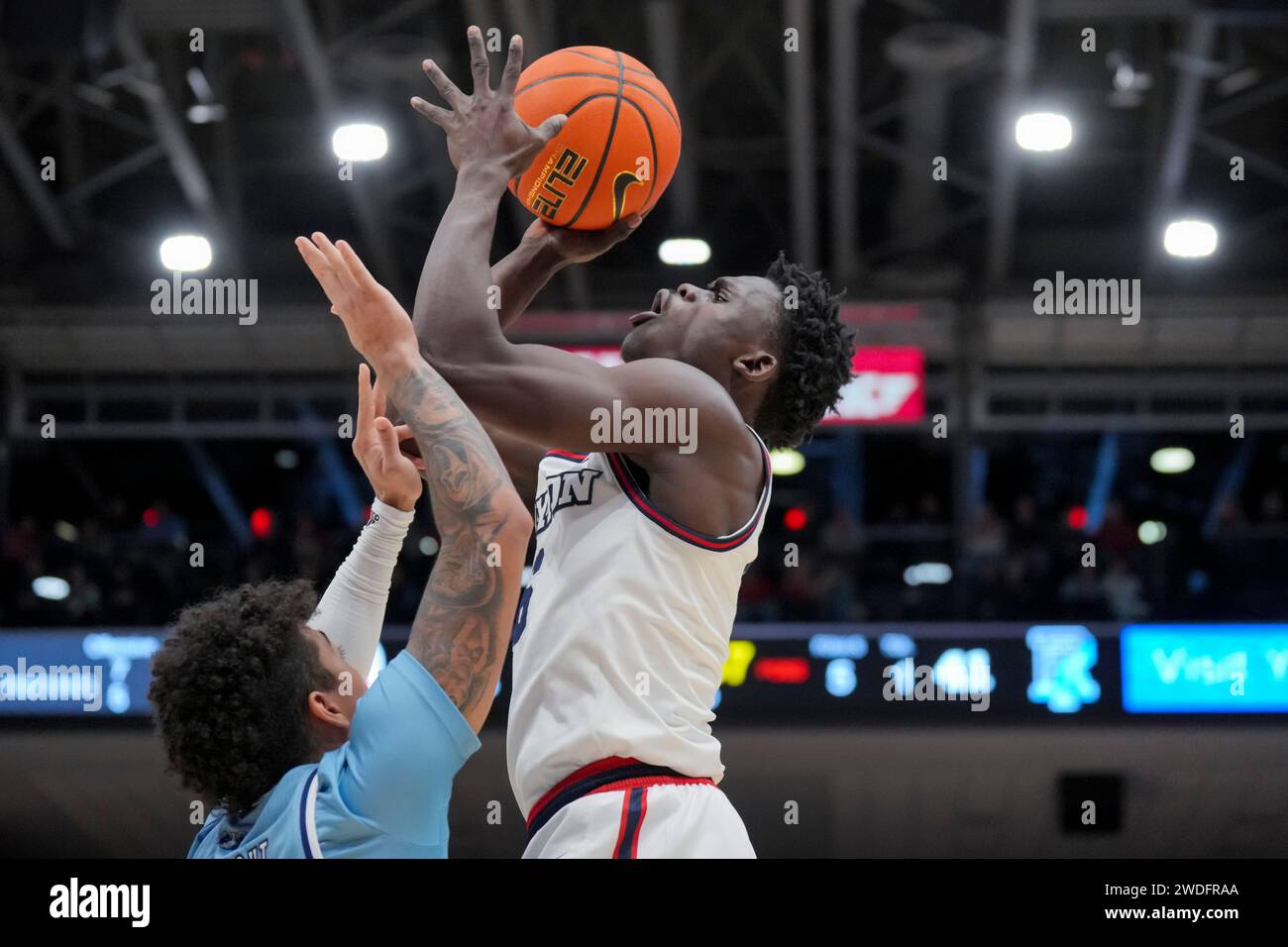 Dayton guard Enoch Cheeks, right, drives to the basket over Rhode ...
